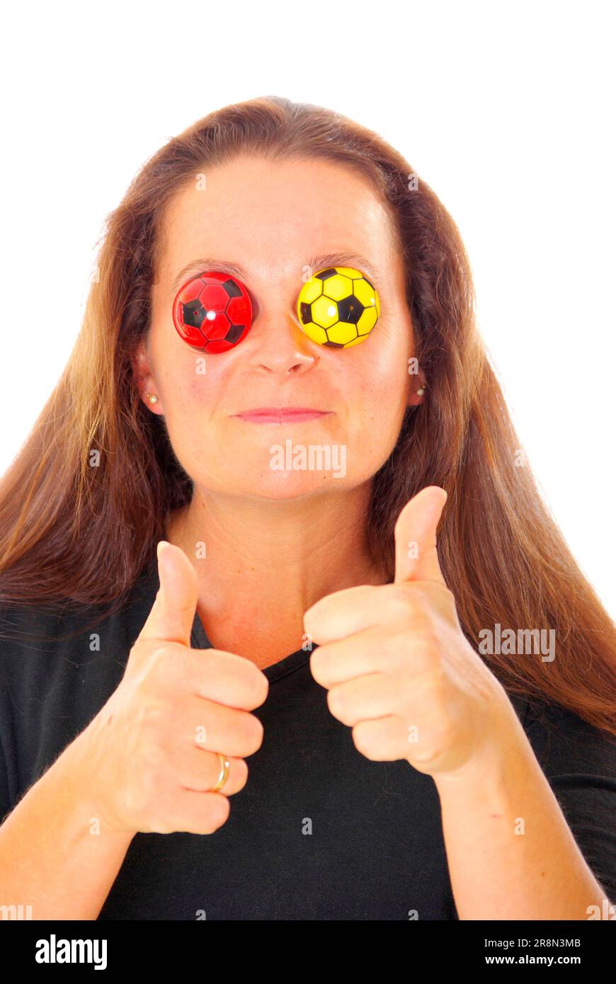 Woman with small footballs on her eyes, football fan, thumbs up, hand ...