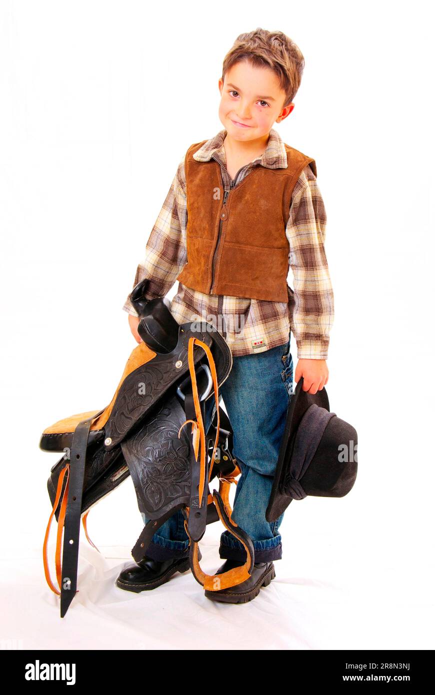Boy with saddle and hat, cowboy, exempted, freestanding Stock Photo - Alamy