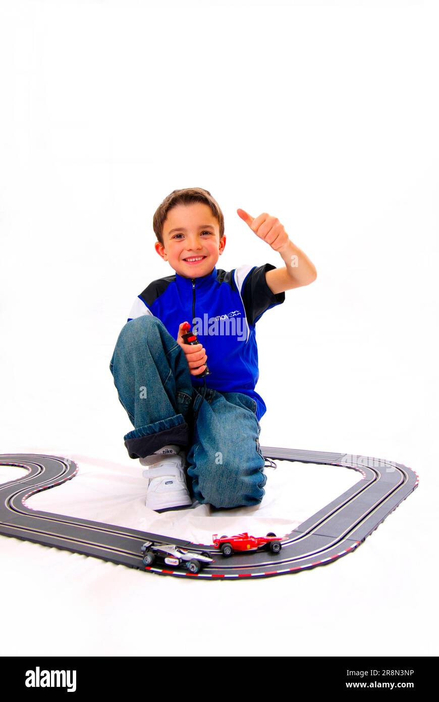 Boy with racetrack, thumbs up, thumbs up, hand signals, toys, play ...