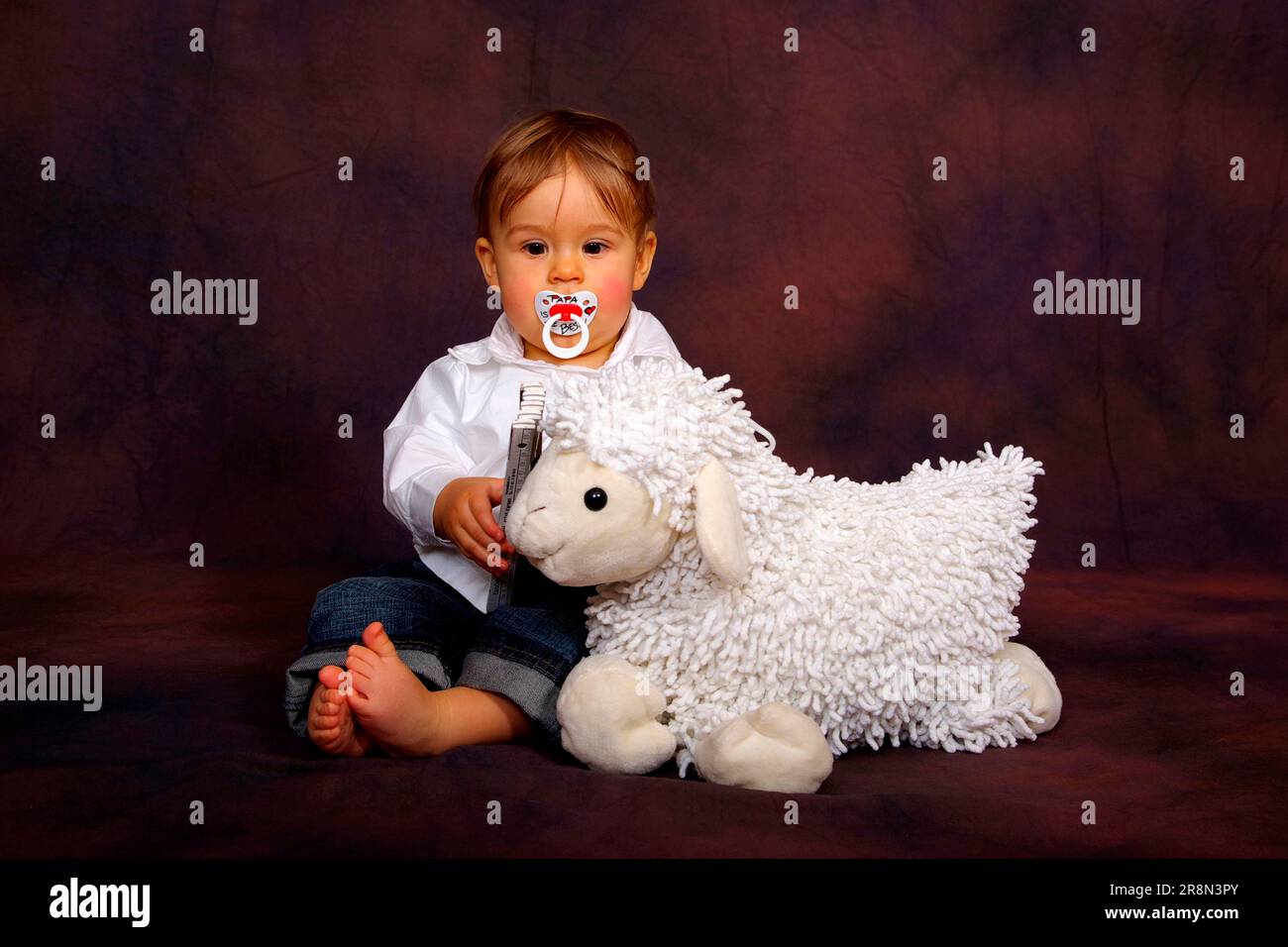Boy with pacifier and cuddly toy, sheep, soft toy Stock Photo - Alamy