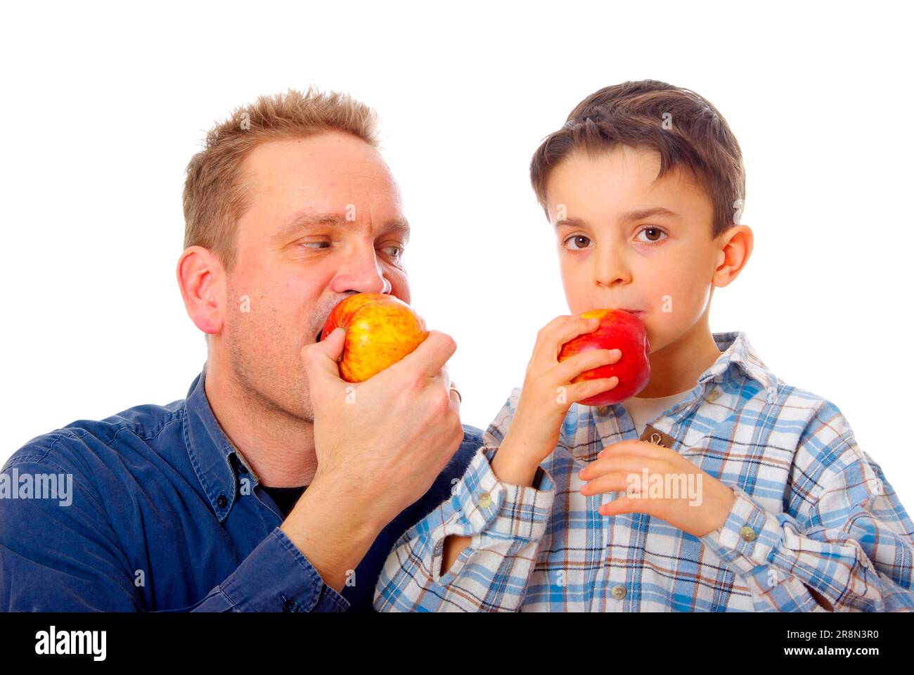 Father and son eating apple Stock Photo - Alamy
