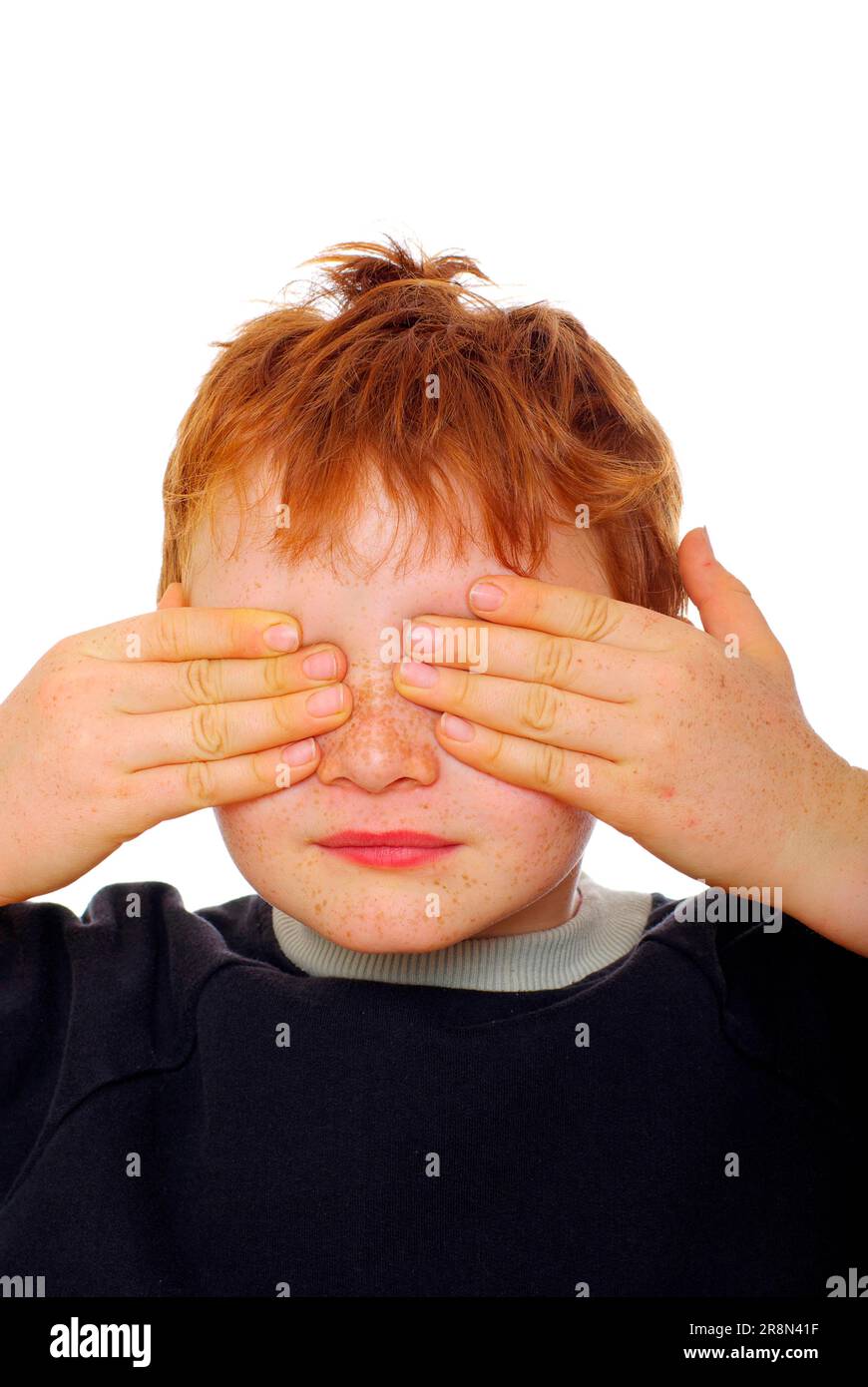 Boy puts his hands in front of his eyes, covers his eyes, covers his ...
