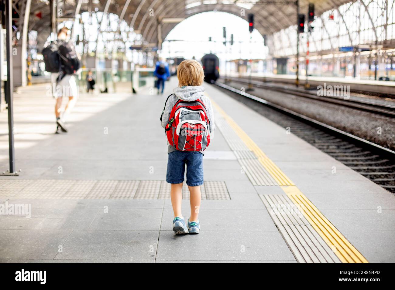 Cute preschool child with backpack, running for the train on a ...