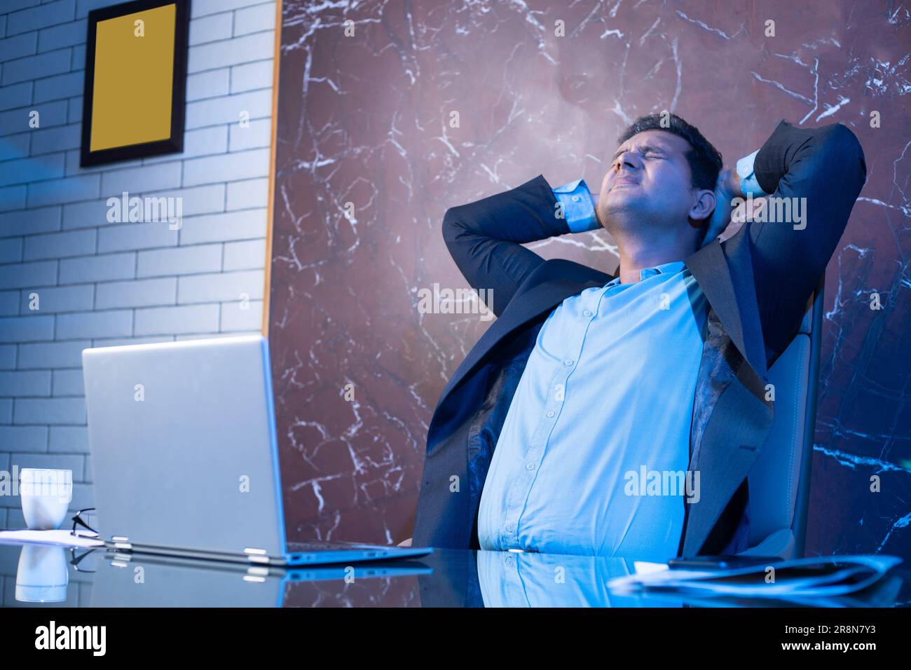 Young indian business man sitting relaxing on chair in office, resting ...