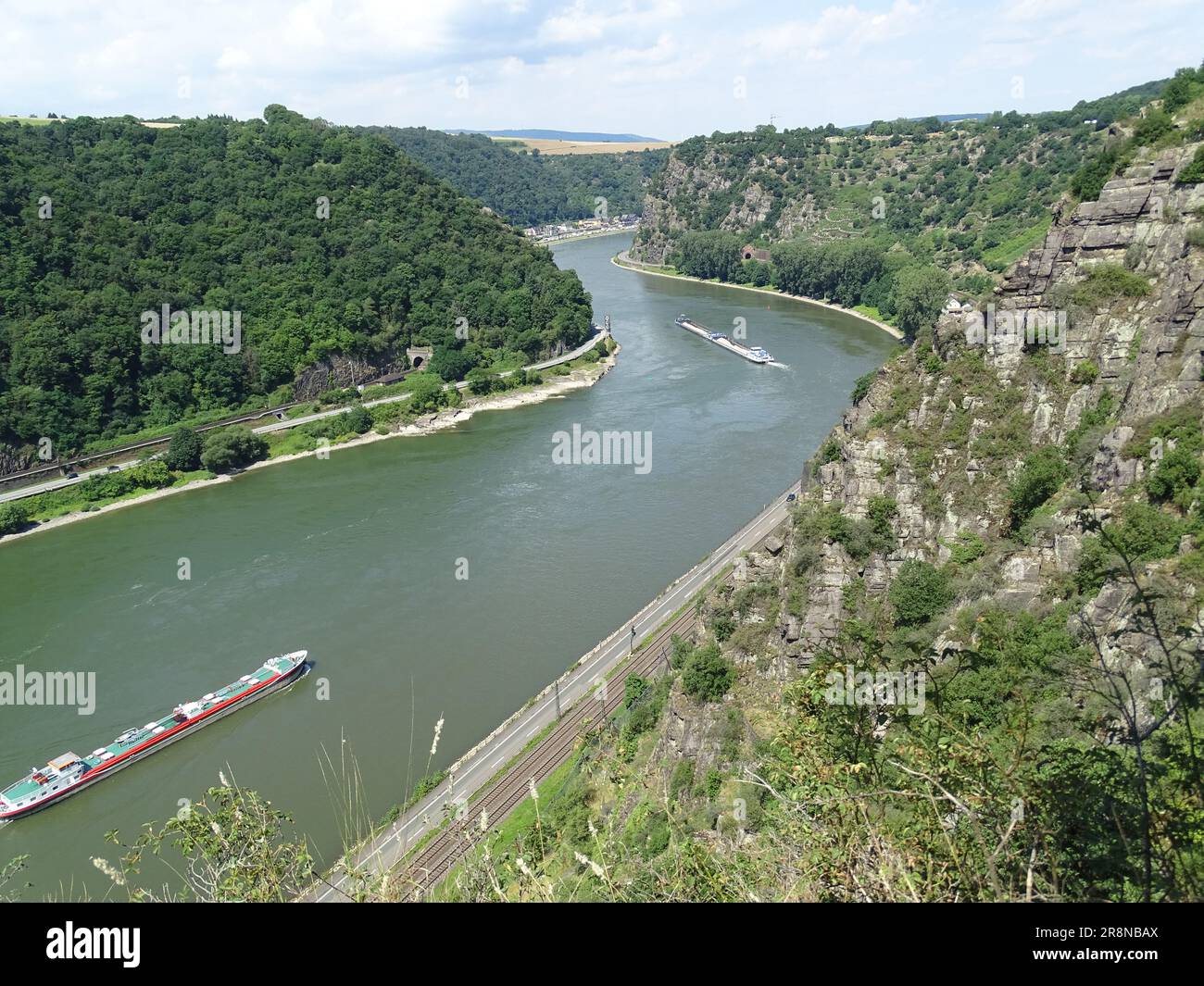 An areal shot of a majestic boat is sailing on a tranquil river beneath a bright blue sky Stock ...