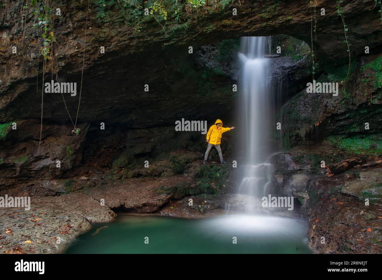 A man waterfall his hand (washes his hands) in the waterfall (water ...