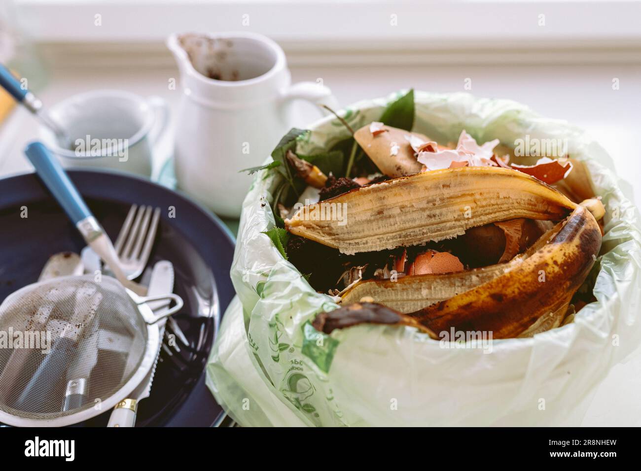 Leftover food in trash can in kitchen Stock Photo - Alamy