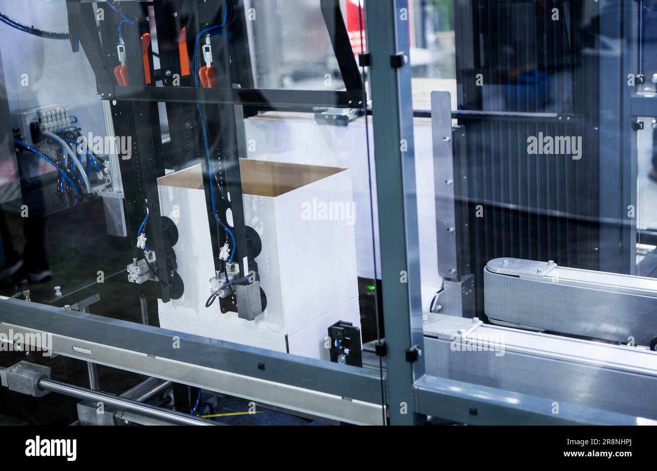 Automatic case erector machine. Industrial warehouse machinery Stock ...