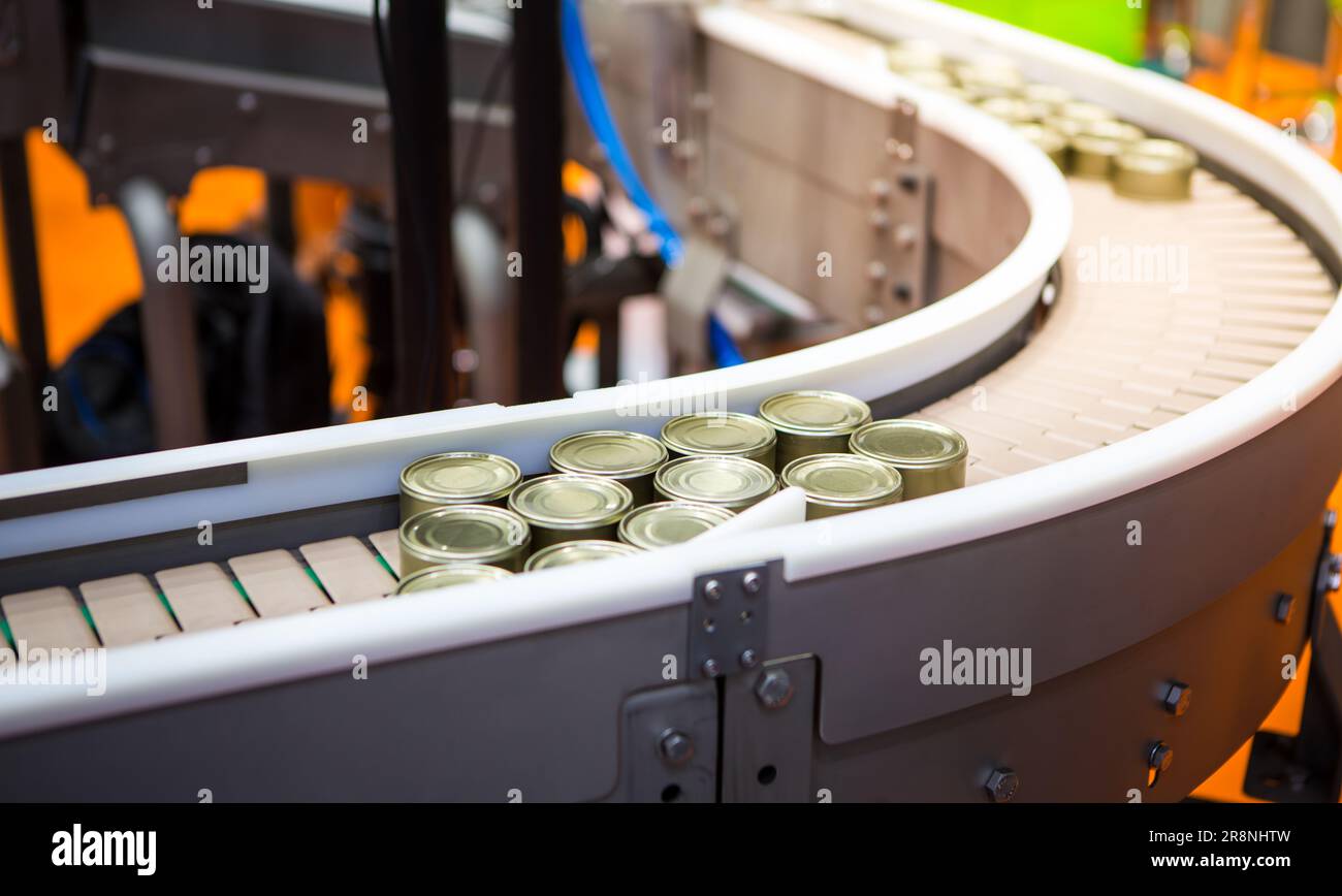 Food canned factory. Food tin cans on belt conveyor. Food industry ...