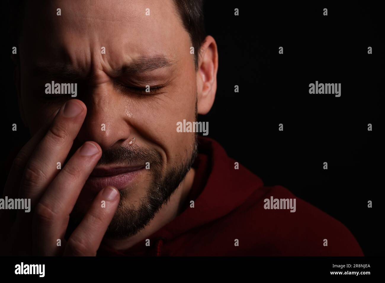 Sad man crying on black background, closeup. Space for text Stock Photo ...