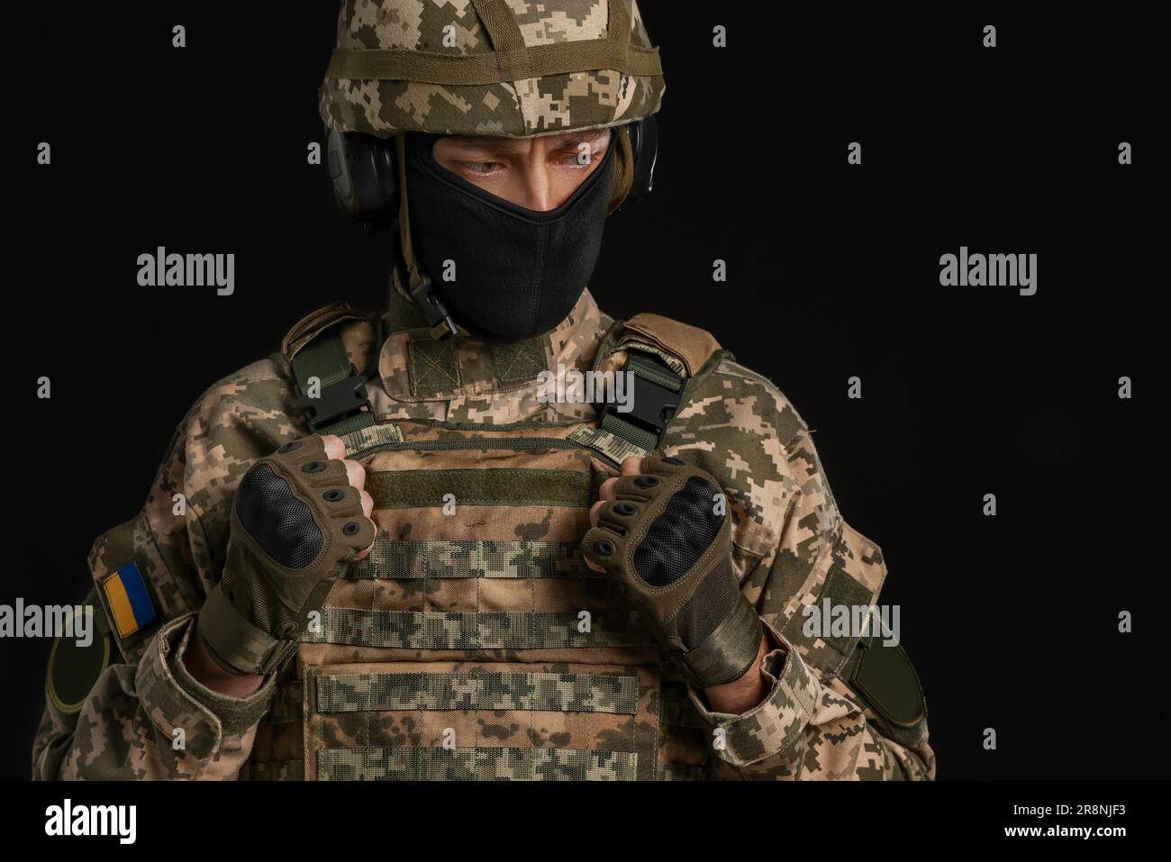 Soldier in Ukrainian military uniform on black background Stock Photo ...