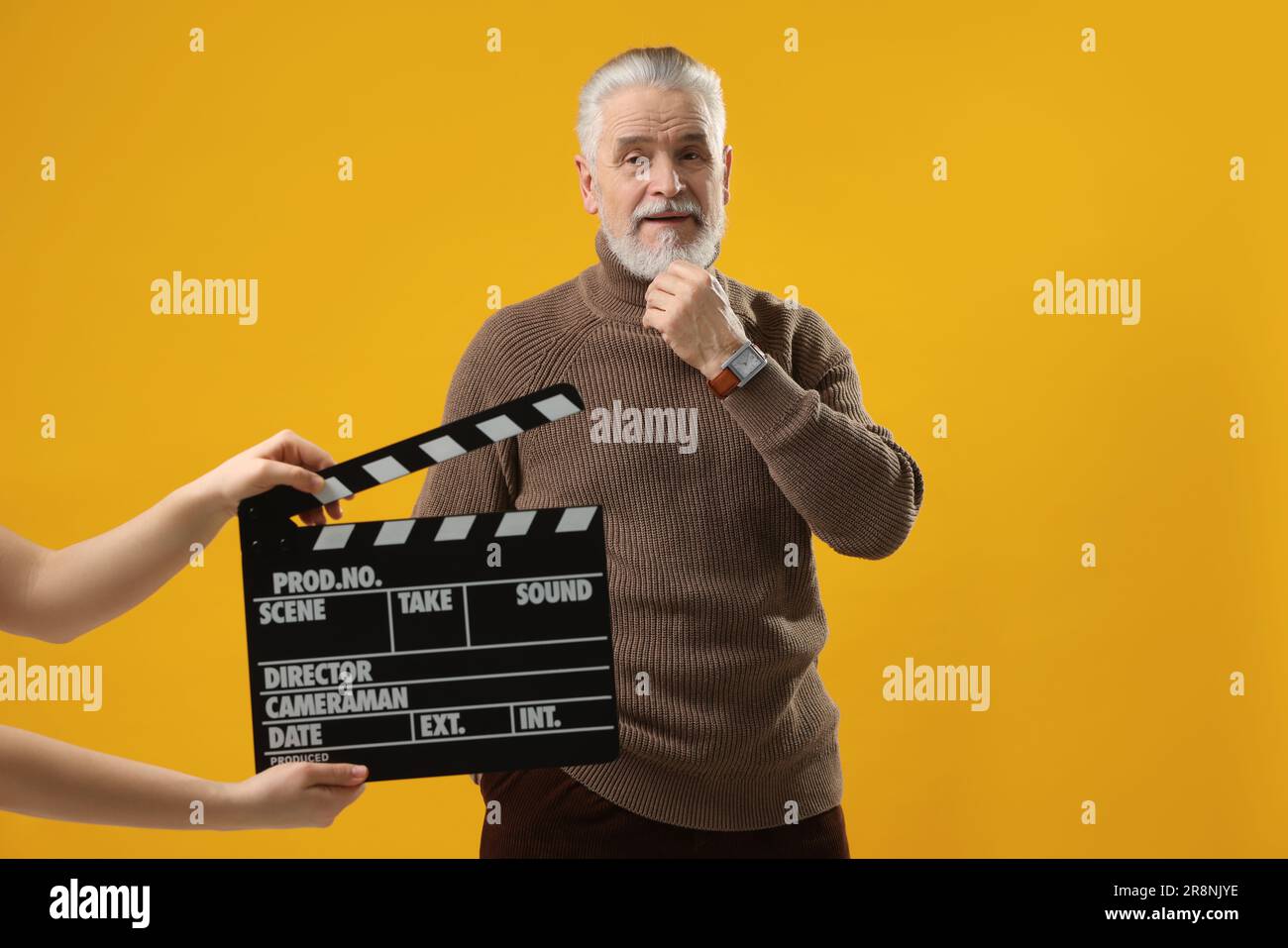 Senior actor performing while second assistant camera holding ...