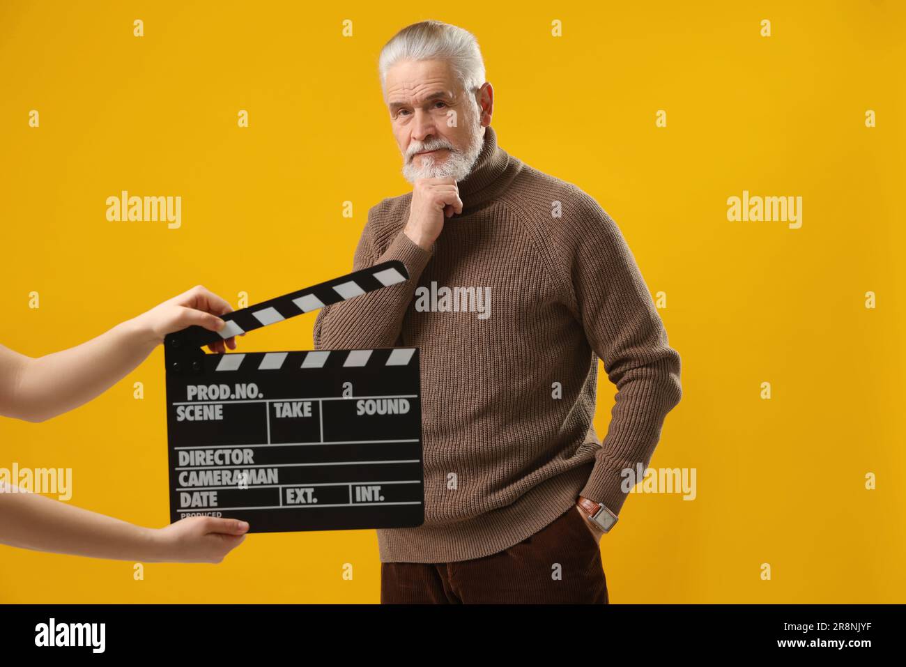 Senior actor performing while second assistant camera holding ...