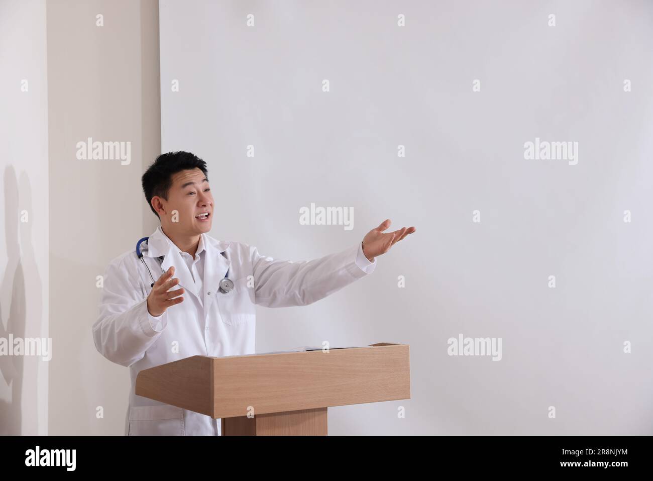 Doctor giving lecture in conference room with projection screen Stock ...