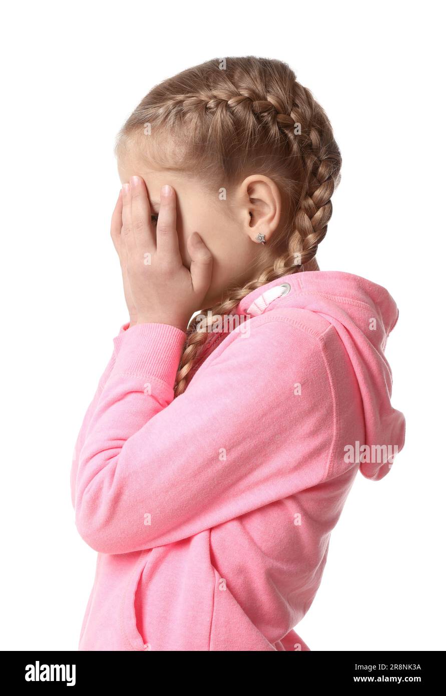 Girl covering face with hands on white background. Children's bullying ...