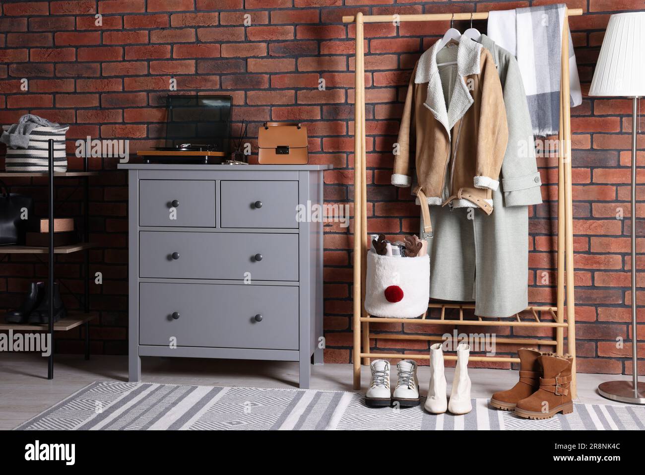 Beautiful hallway interior with coat rack, chest of drawers and shoe ...