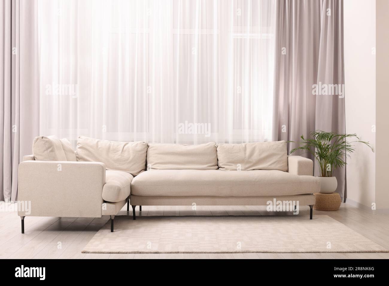 Comfortable sofa and window with beautiful curtains in room. Interior ...