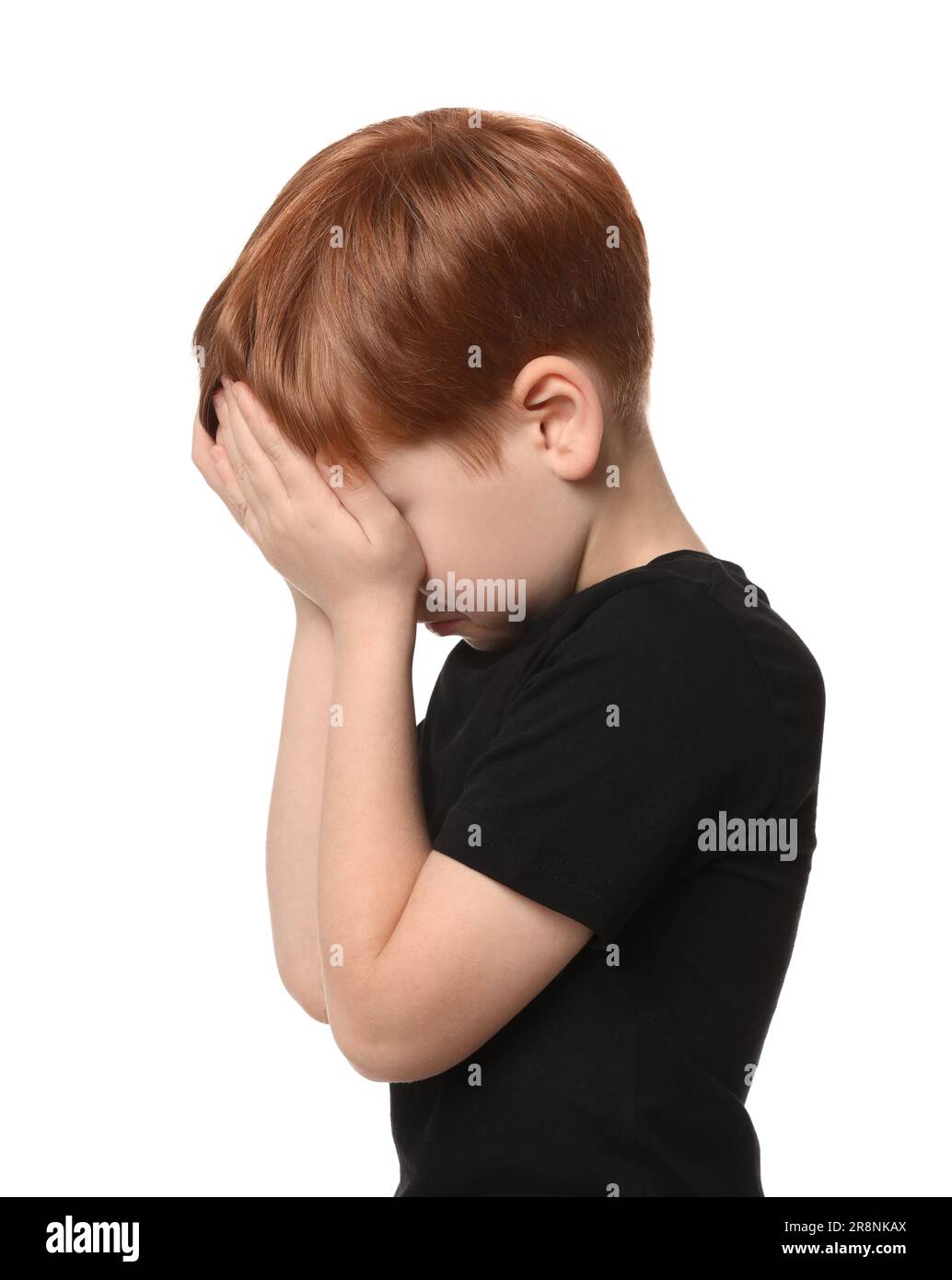 Boy covering face with hands on white background. Children's bullying ...