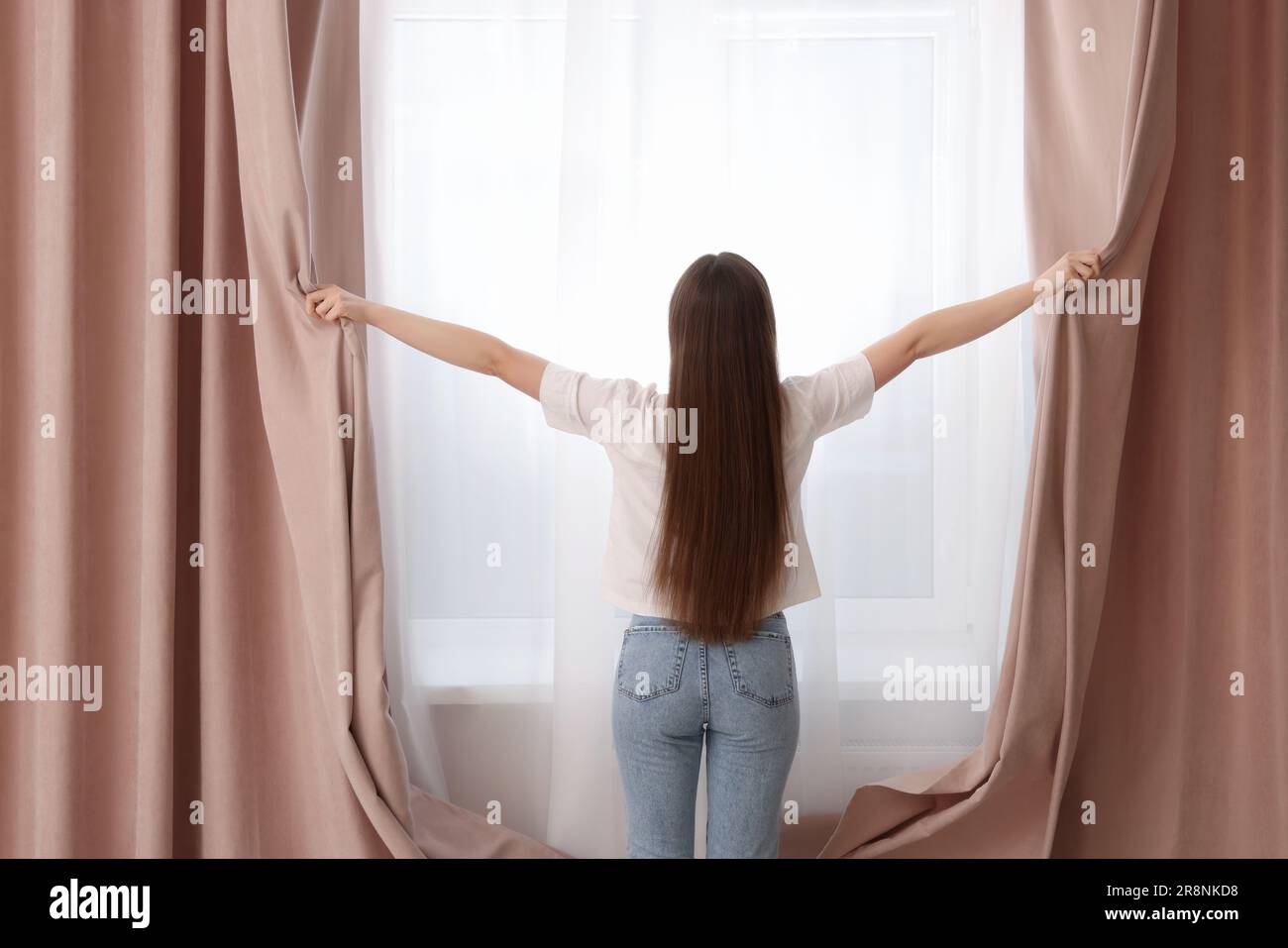 Woman opening stylish curtains hi-res stock photography and images - Alamy