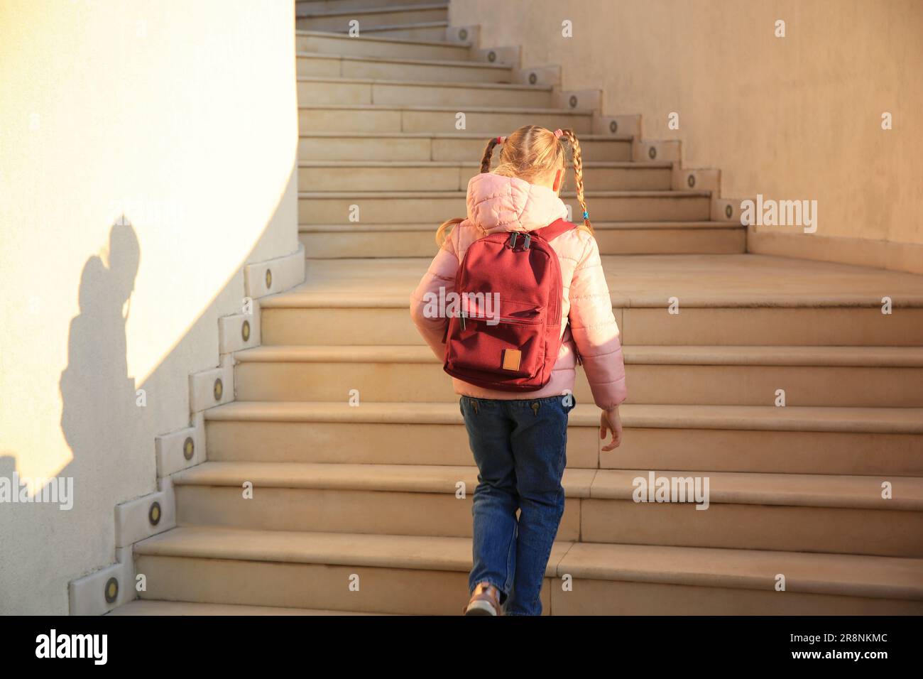Cute little girl with backpack on stairs outdoors, back view Stock ...