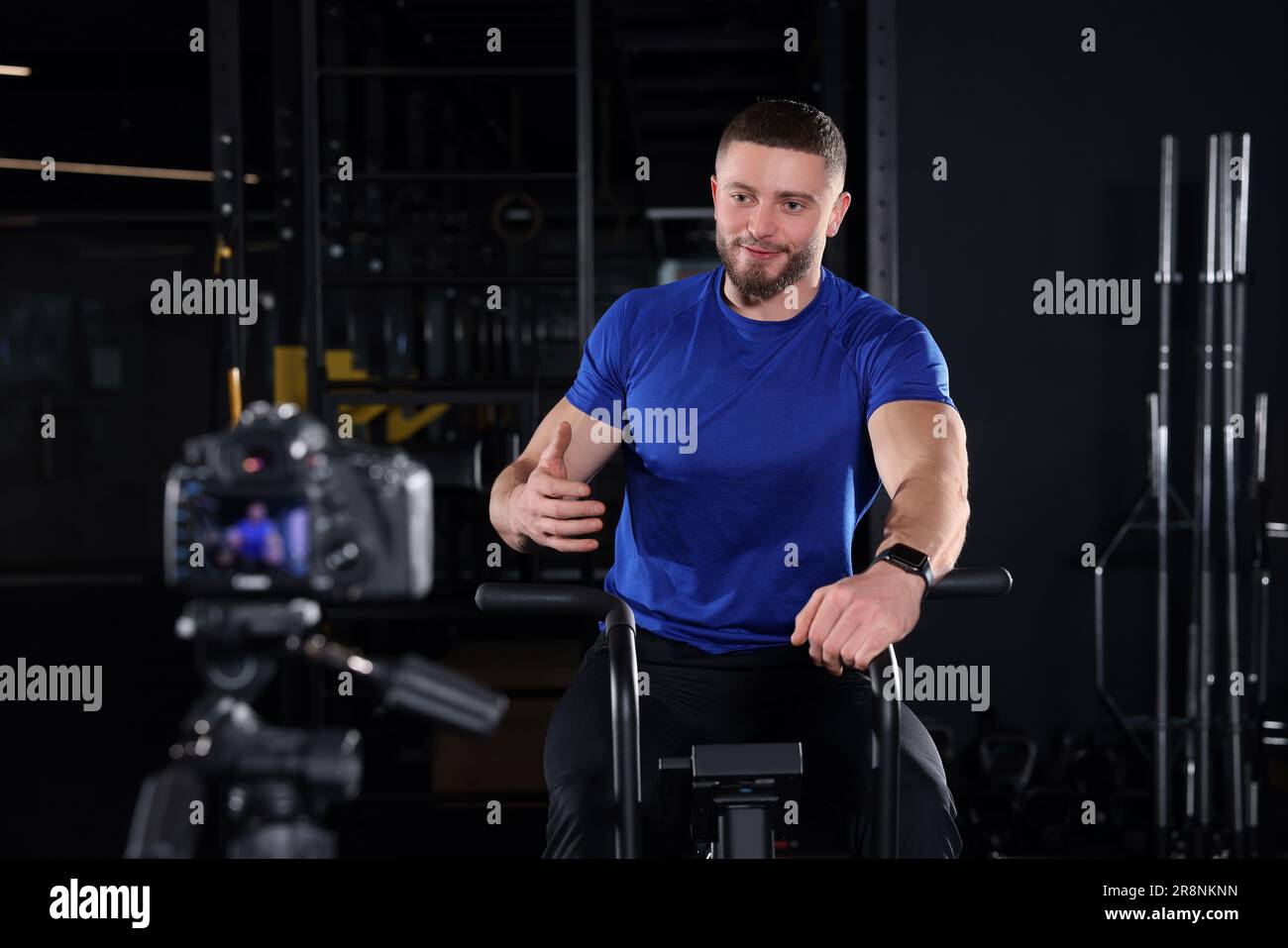 Man recording workout on camera at gym. Online fitness trainer Stock ...