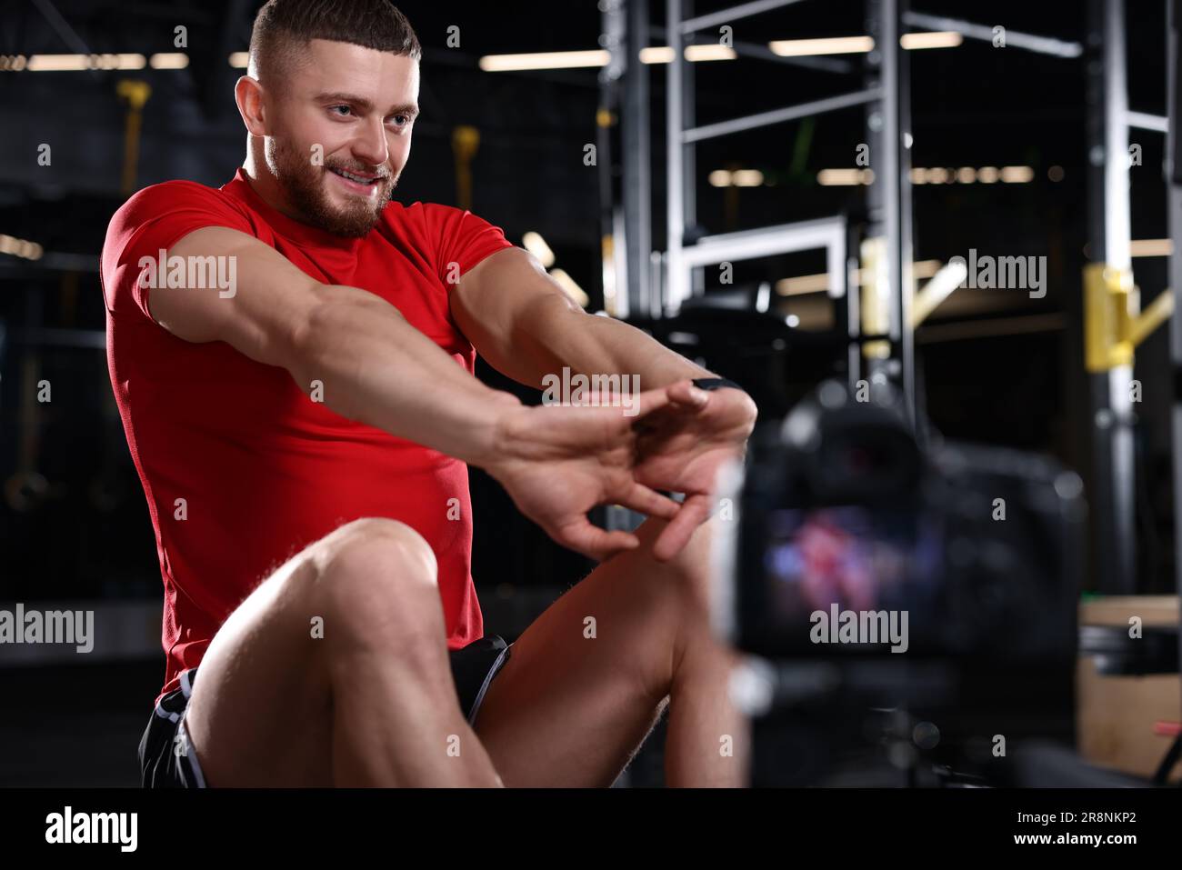 Man recording workout on camera at gym. Online fitness trainer Stock ...