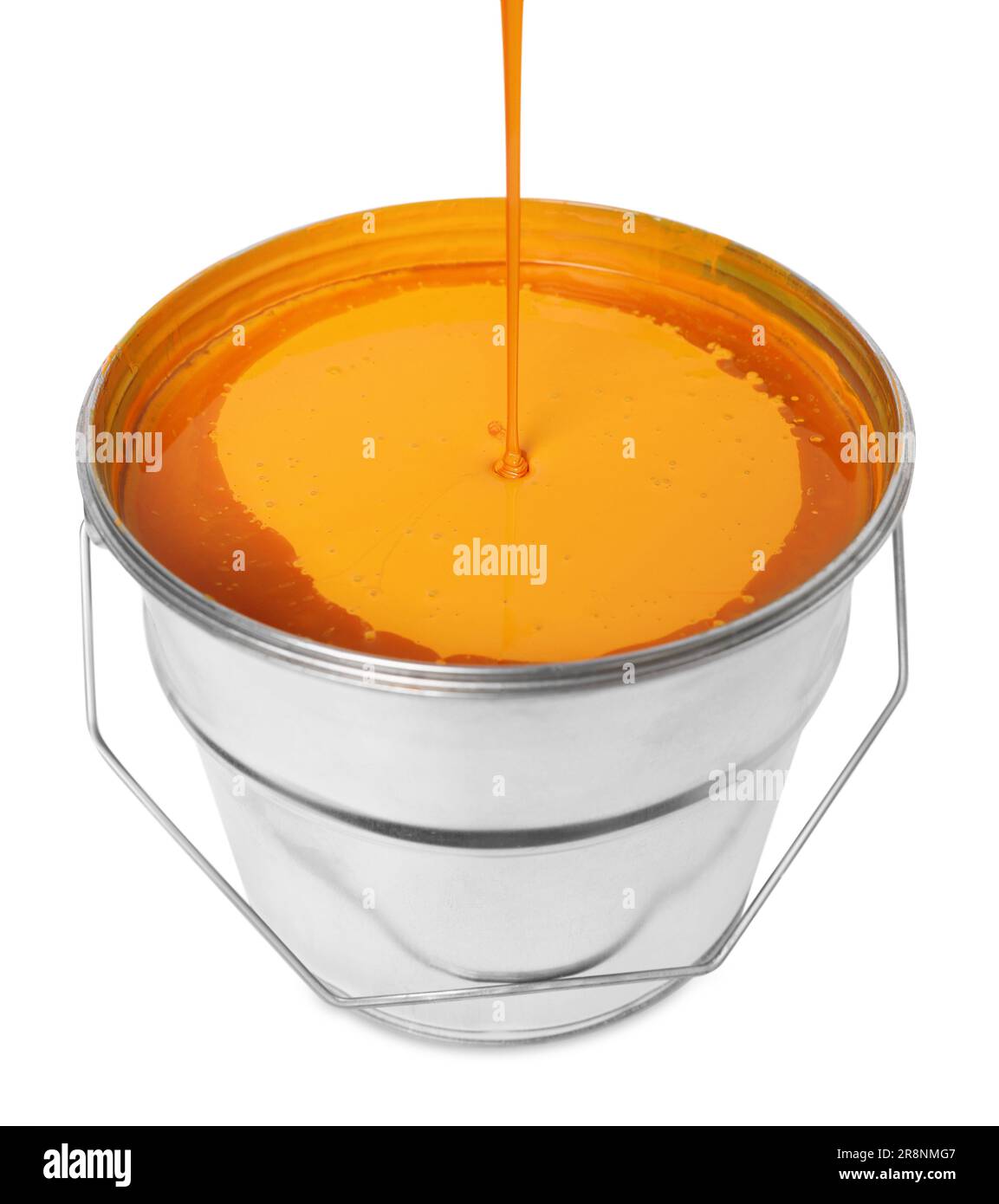 Pouring orange paint into bucket on white background Stock Photo - Alamy