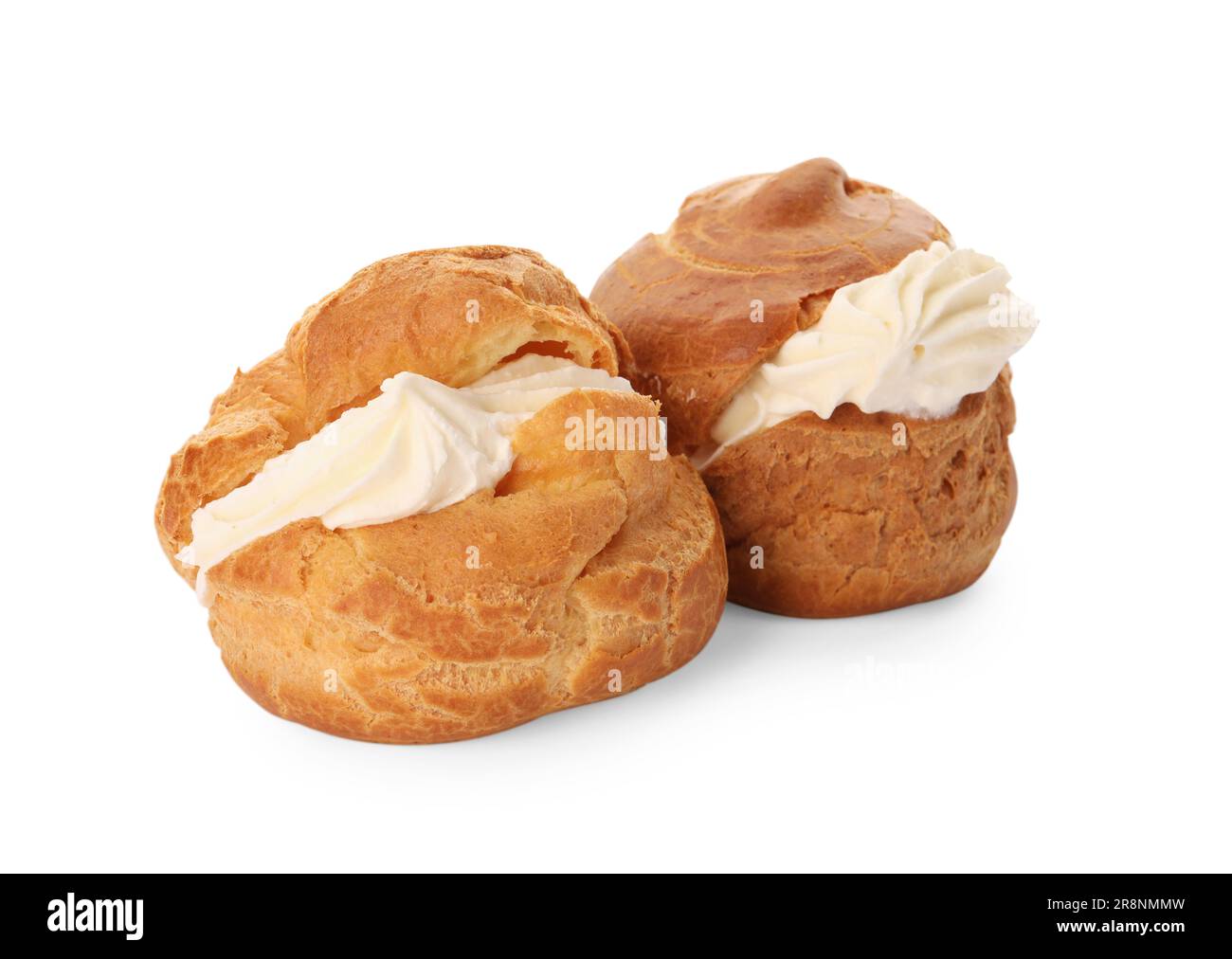 Delicious profiteroles with cream filling on white background Stock ...