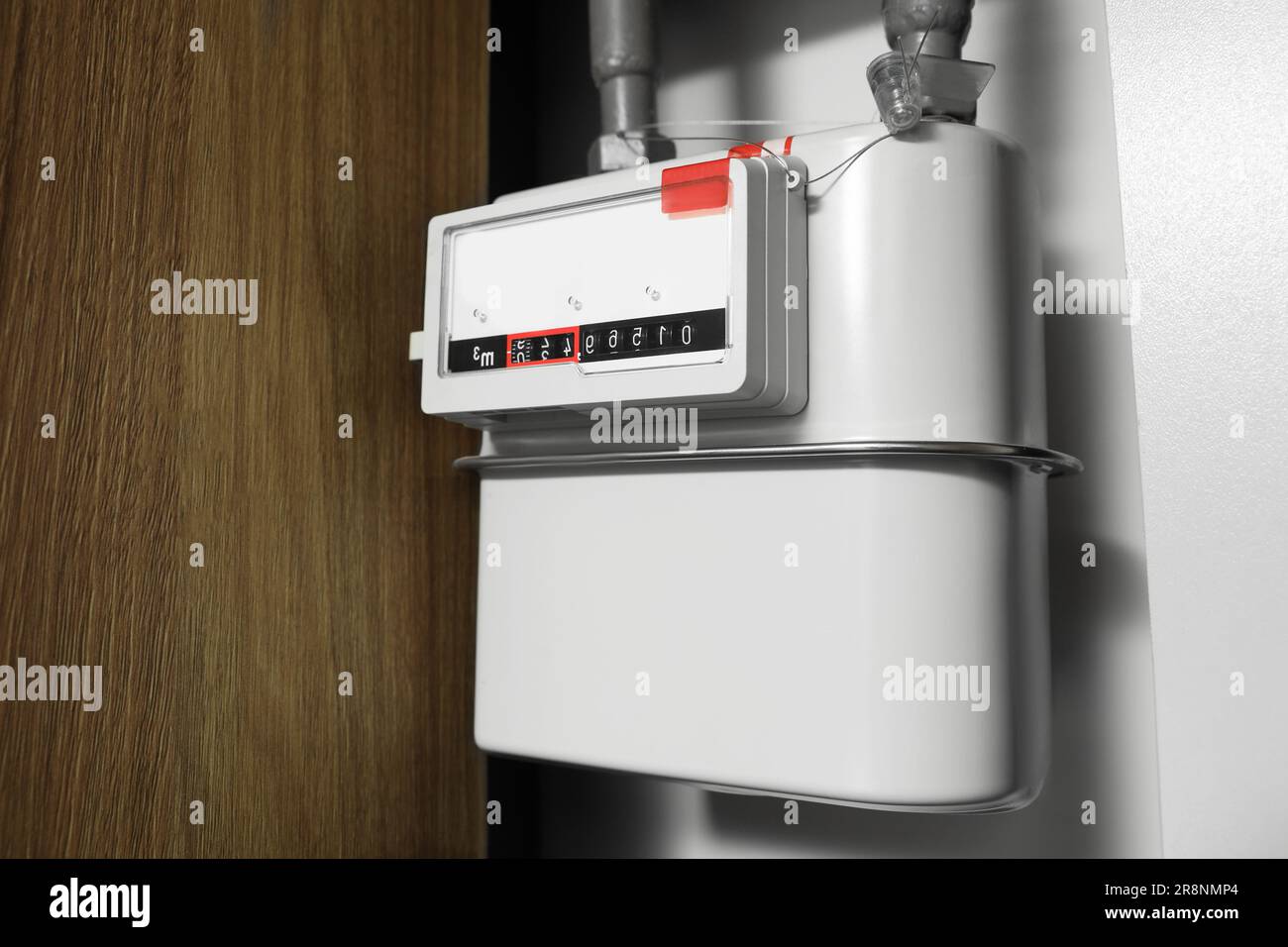 Electric meter near white wall. Gas measuring device Stock Photo - Alamy