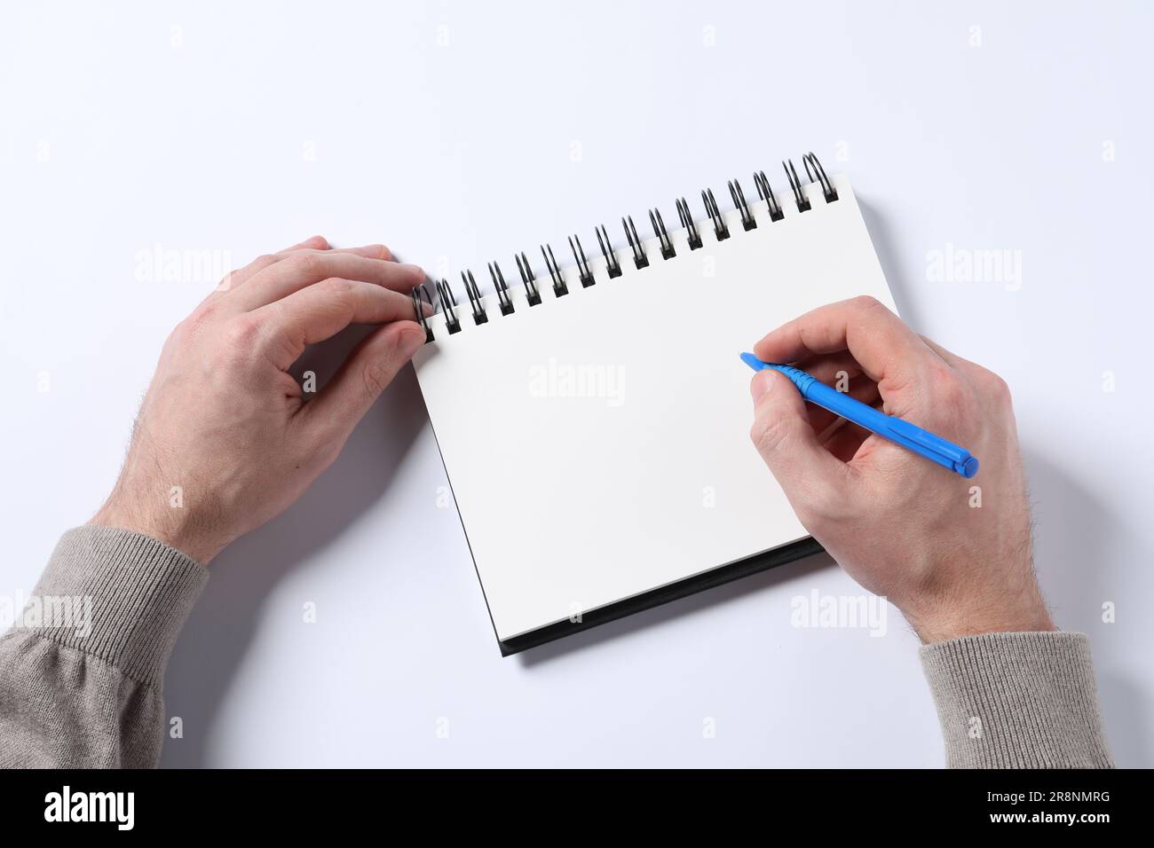 Man with pen and empty notepad on white background, top view Stock ...