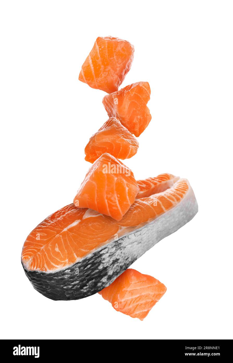 Cut fresh salmon falling on white background Stock Photo - Alamy
