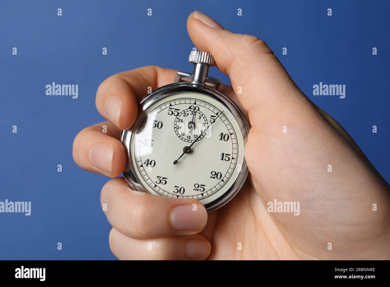 Woman holding vintage timer on blue background, closeup Stock Photo - Alamy