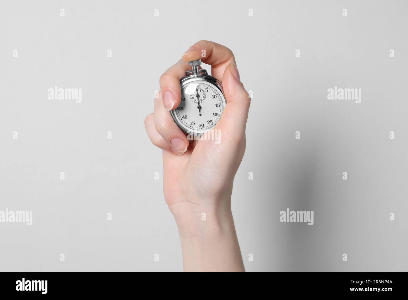 Woman holding vintage timer on light grey background, closeup Stock ...