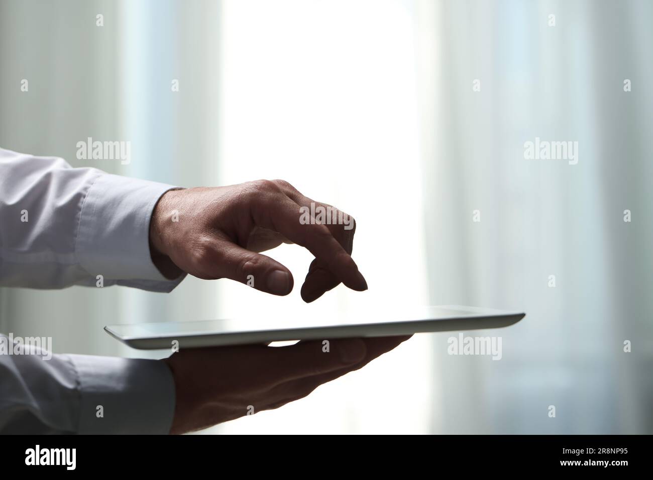 Closeup view of man using new tablet indoors Stock Photo - Alamy