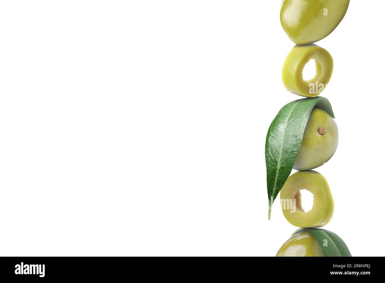 Cut and whole green olives with leaves on white background Stock Photo ...