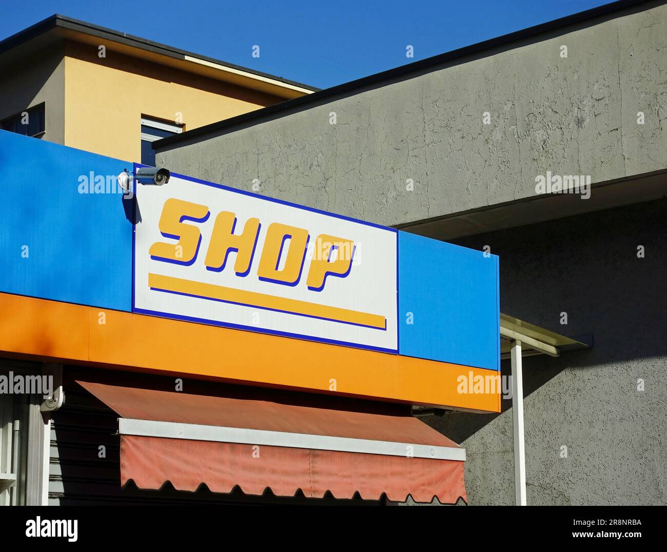 shop sign with a CCTV camera installed on the wall Stock Photo - Alamy
