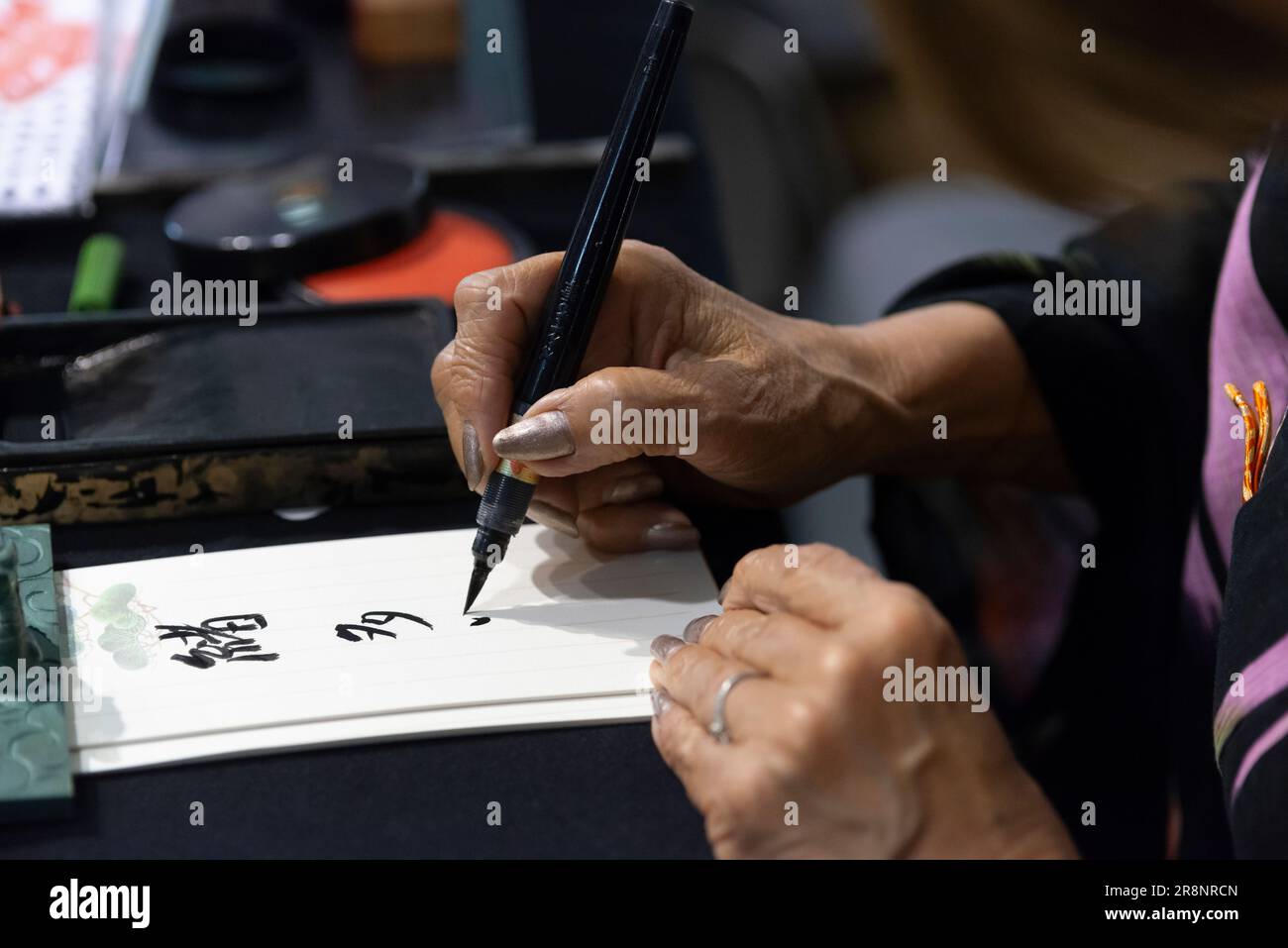 Woman Writes Japanese Characters Stock Photo - Alamy
