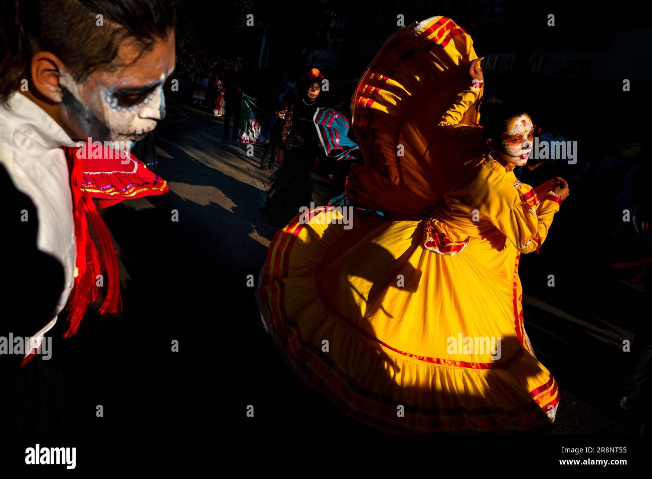 A young Mexican woman, dressed as La Catrina, performs a dance act ...