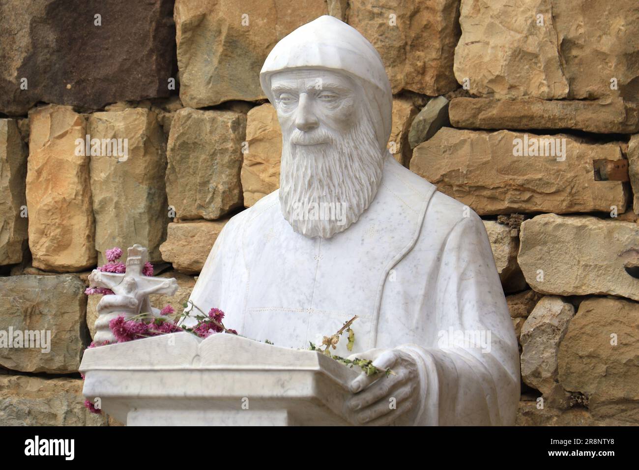 A statue of Mar Charbel, the Lebanese saint, holding a crucifix Stock ...