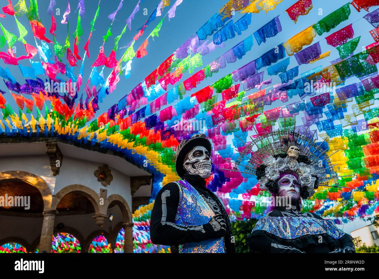 A Mexican woman, dressed as La Catrina, and a Mexican man, dressed as ...