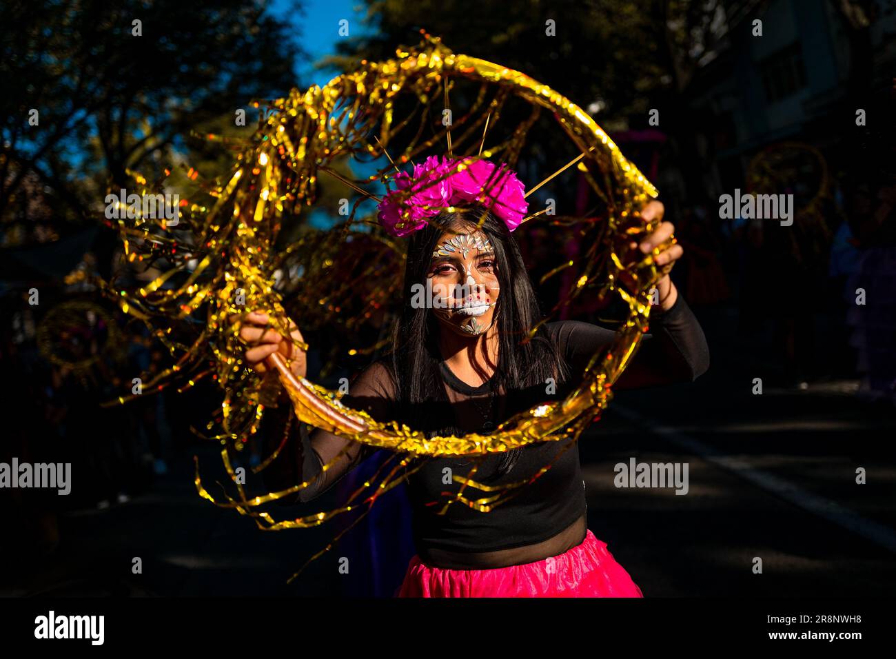 A young Mexican woman, wearing La Catrina face paint, performs a dance ...