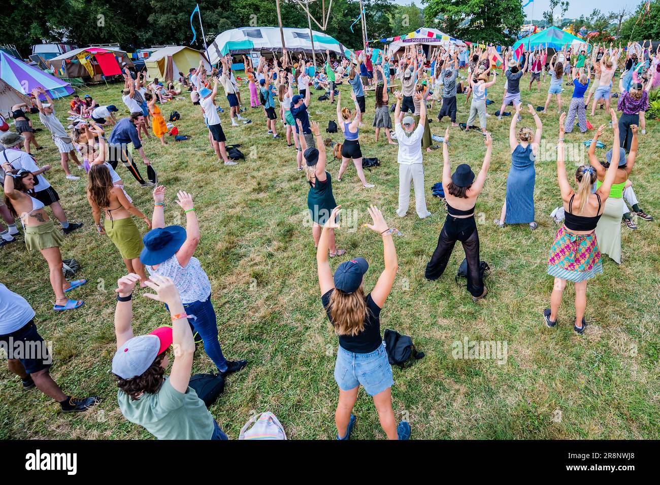 Glastonbury, UK. 22nd June, 2023. A large outdoor yoga class - The ...