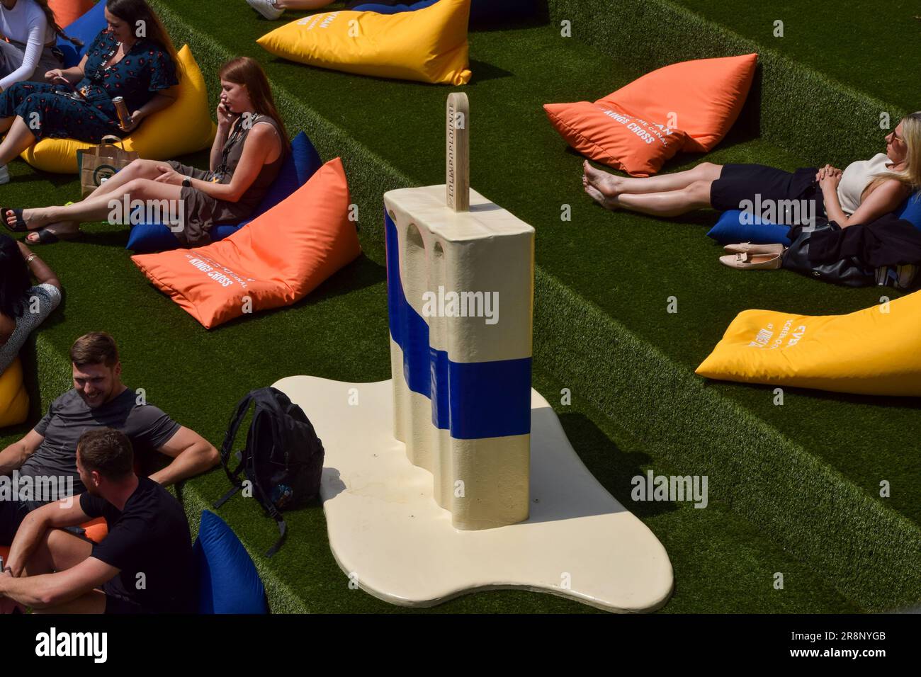 People enjoy the sunshine next to giant 'melting ice lolly' sculptures ...