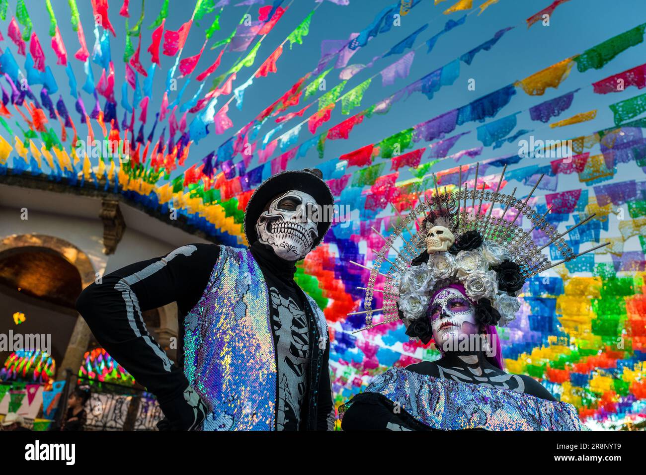 A Mexican woman, dressed as La Catrina, and a Mexican man, dressed as ...