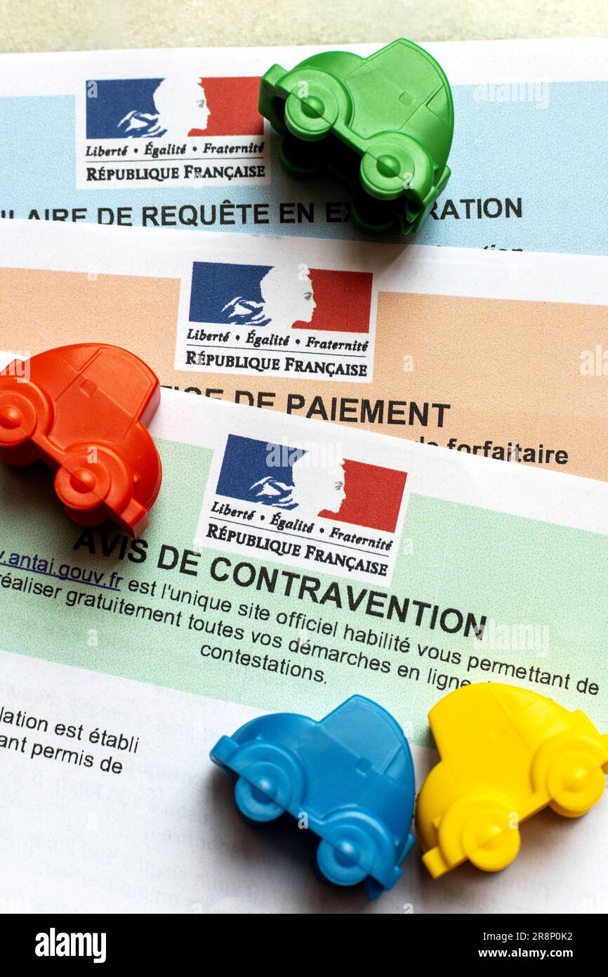 Colorful toy cars placed on French administrative documents featuring ...