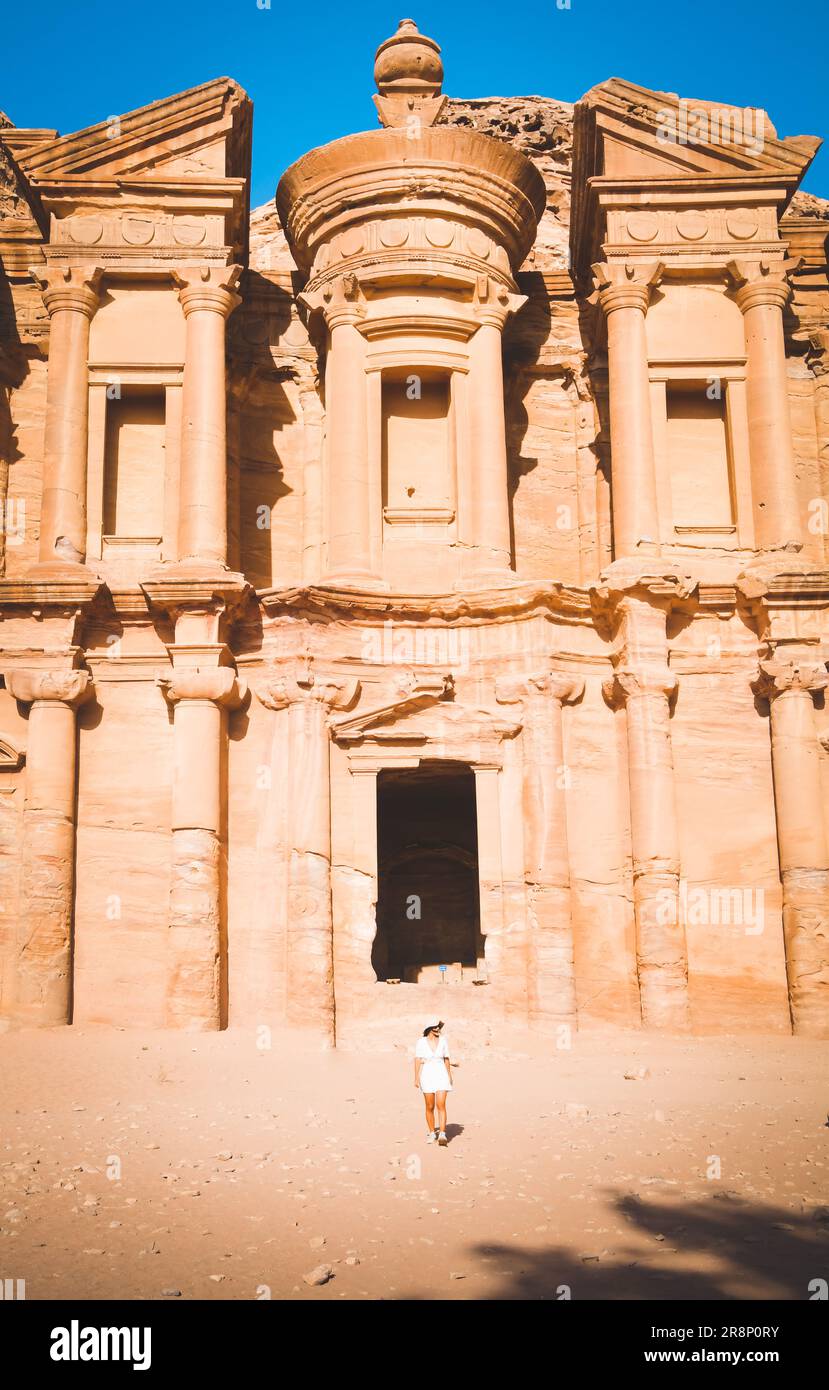 Cinematic Petra background caucasian young woman in white dress and hat ...
