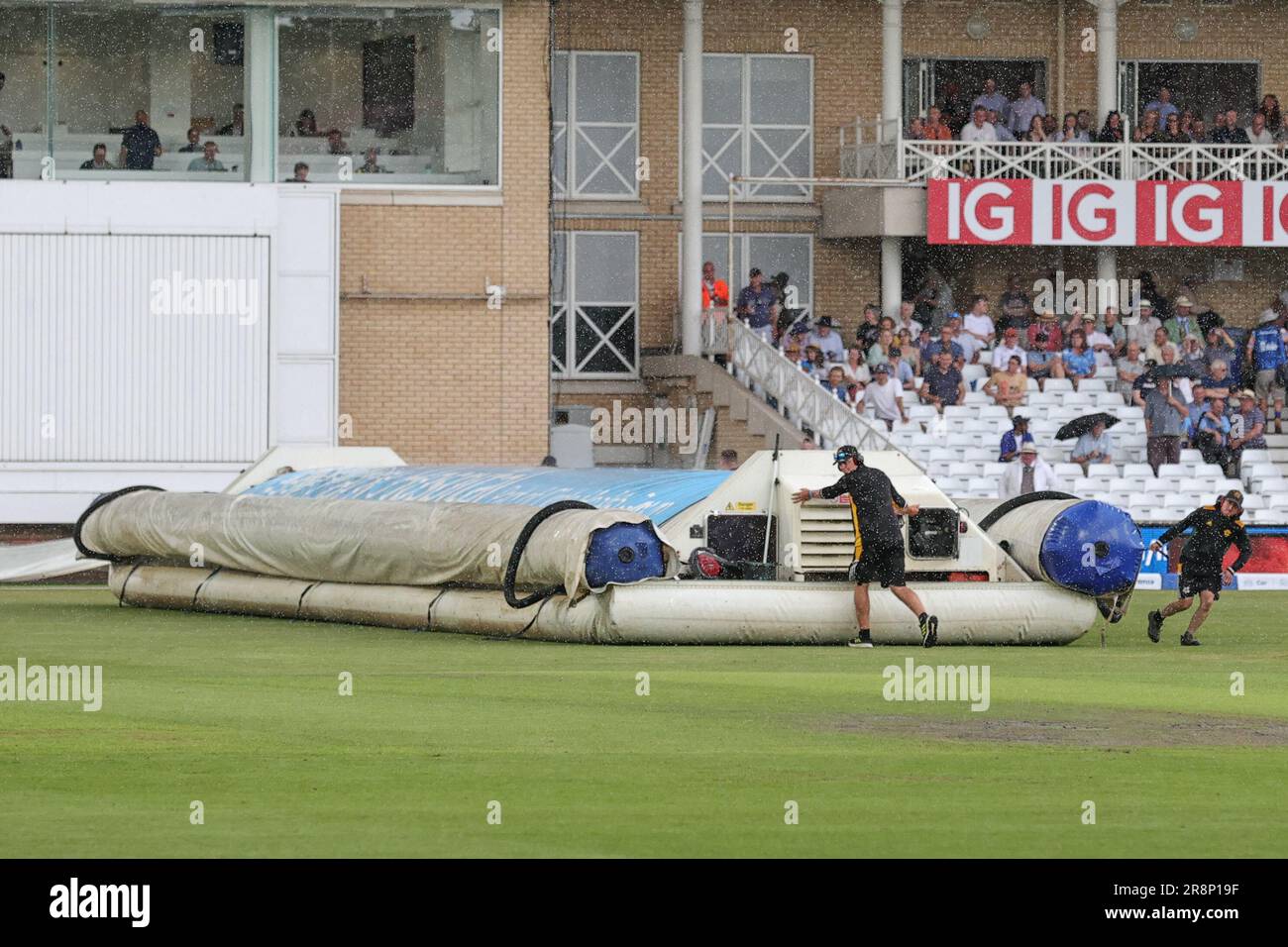 Ground staff bring out covers for rain during the Metro Bank Women's ...