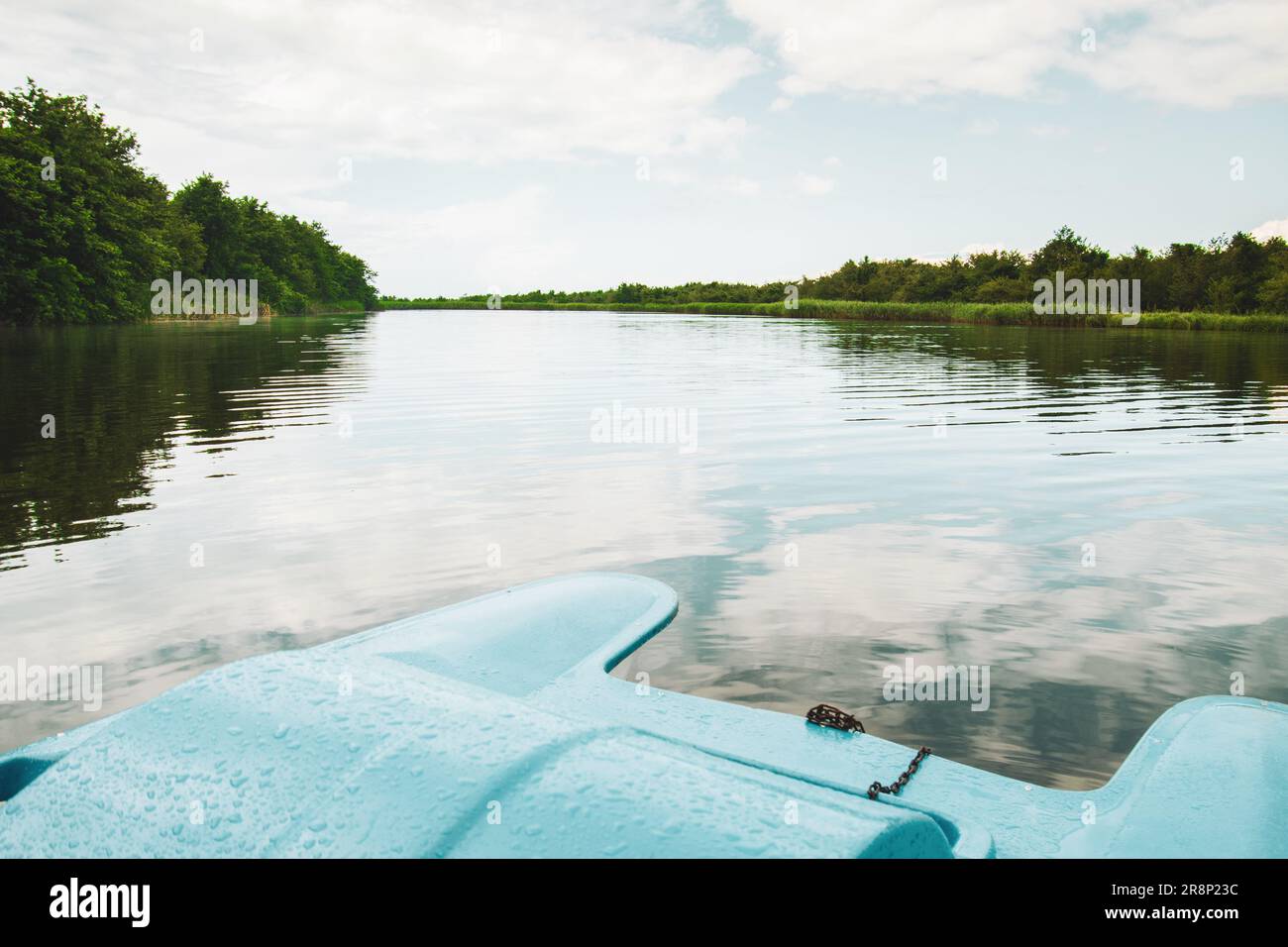 Blue pedal boat together in Kolkheti national park in cloudy summer day ...