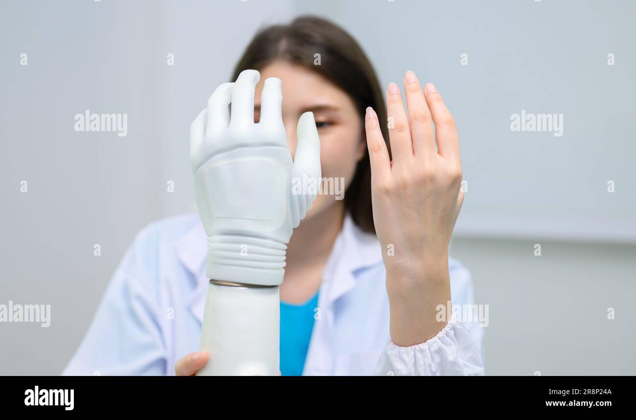 Technician testing robotic bionic arm at prosthetic manufacturing Stock ...