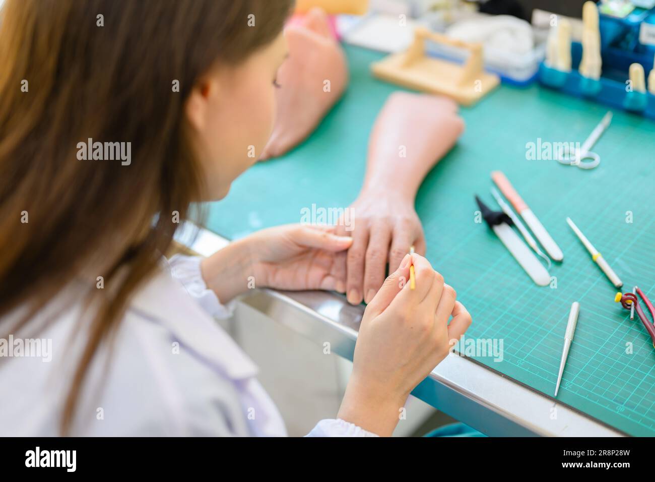 Technician making prosthetic limb device at laboratory Stock Photo - Alamy